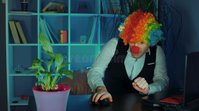 Young Man in Image of Clown Afraid of Computer Mouse in Office. Funny ...