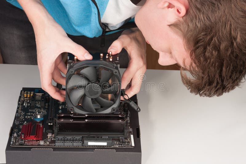 Young Man Installing CPU Cooler Fan on New, Modern Gaming Mother Stock ...