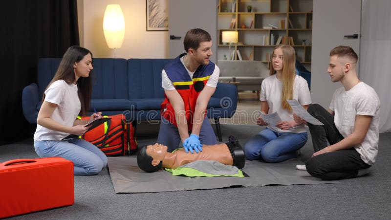 Young Man Instructor Preparing To Make First Aid Heart Compressions ...