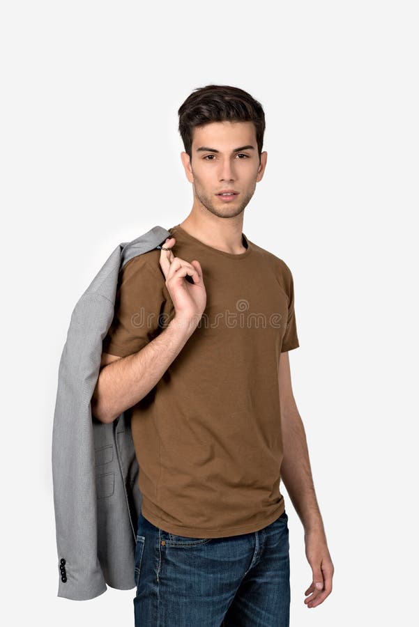 The Young Man in a Jacket and Jeans Looks at Camera. Stock Photo ...
