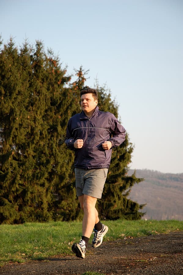 Young Man Jogging stock photo. Image of running, grass - 2165426
