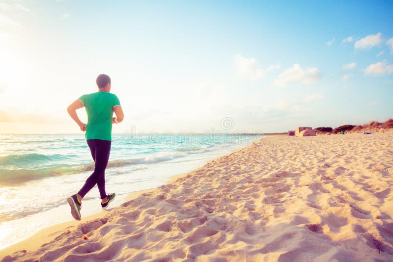 Young Man Jogging on the Beach Stock Image - Image of backlit, waves ...