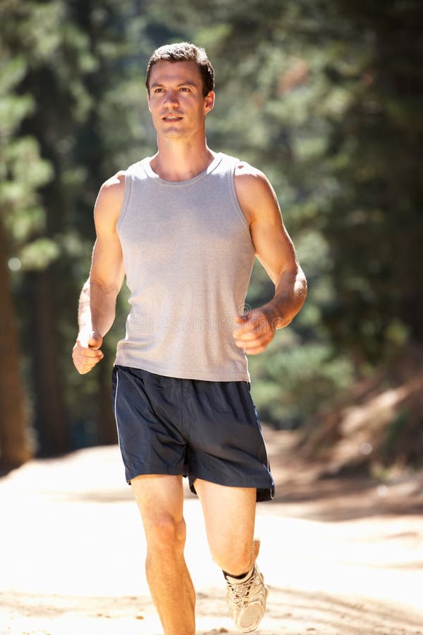 Young Man Jogging through the Countryside Stock Image - Image of ...