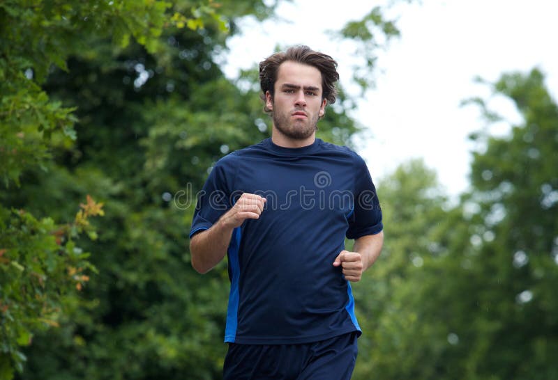 Young man jogging outdoors stock photo. Image of forest - 42922786