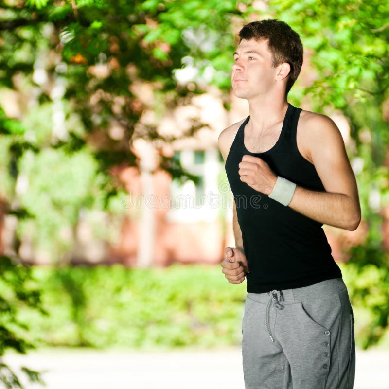Young man jogging in park stock photo. Image of road - 22030562