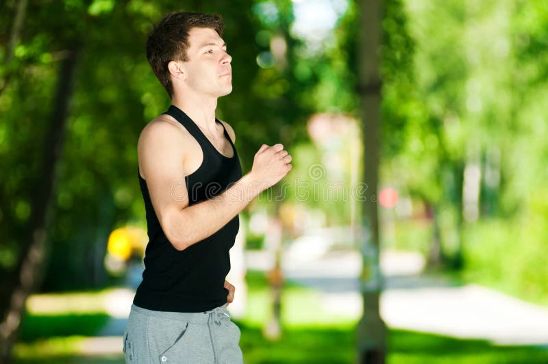 Young man jogging in park stock photo. Image of handsome - 23123168
