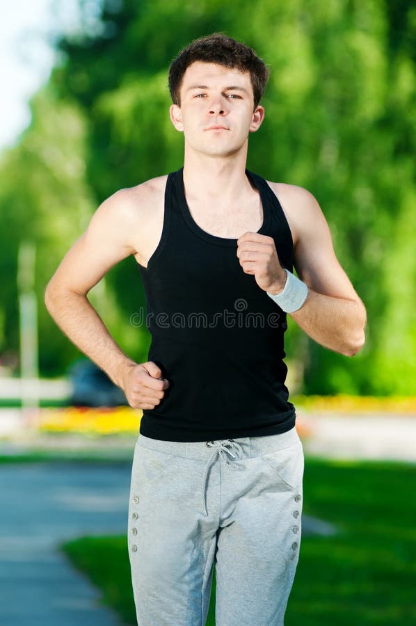 Young man jogging in park stock image. Image of jogger - 24017127