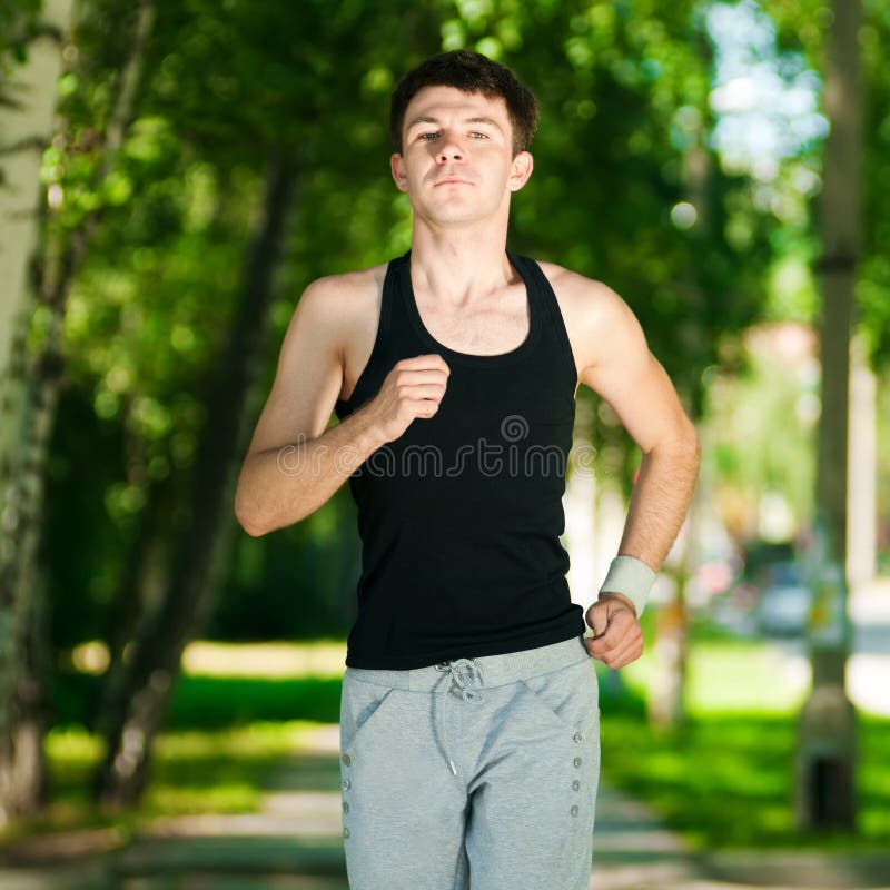 Young man jogging in park stock image. Image of jogger - 24017143