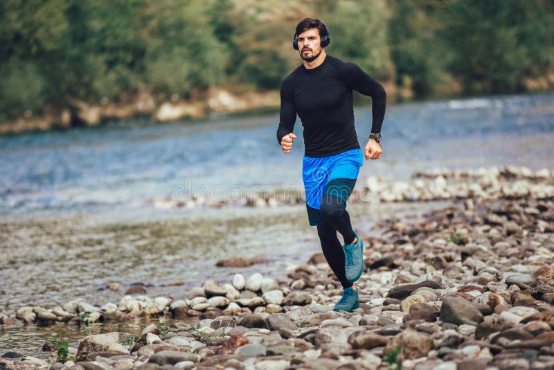 Young Man Jogging on River Bank Stock Photo - Image of muscular, body ...