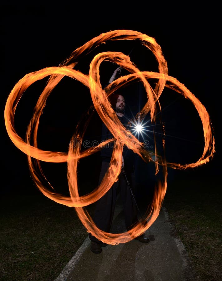 Juggling flaming batons editorial stock photo. Image of juggle - 42871428