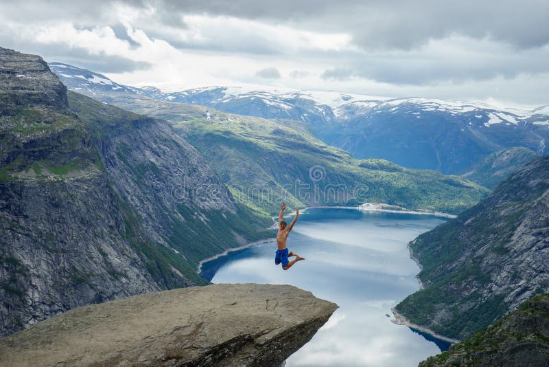 Young Man Jump on the Edge Trolltunga. Norway Stock Photo - Image of ...