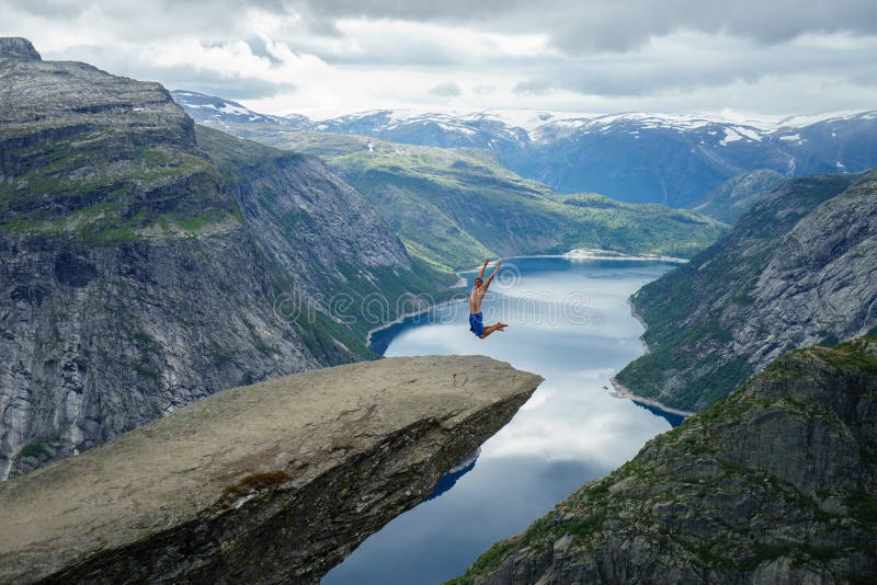 Young Man Jump on the Edge Trolltunga. Norway Stock Photo - Image of ...