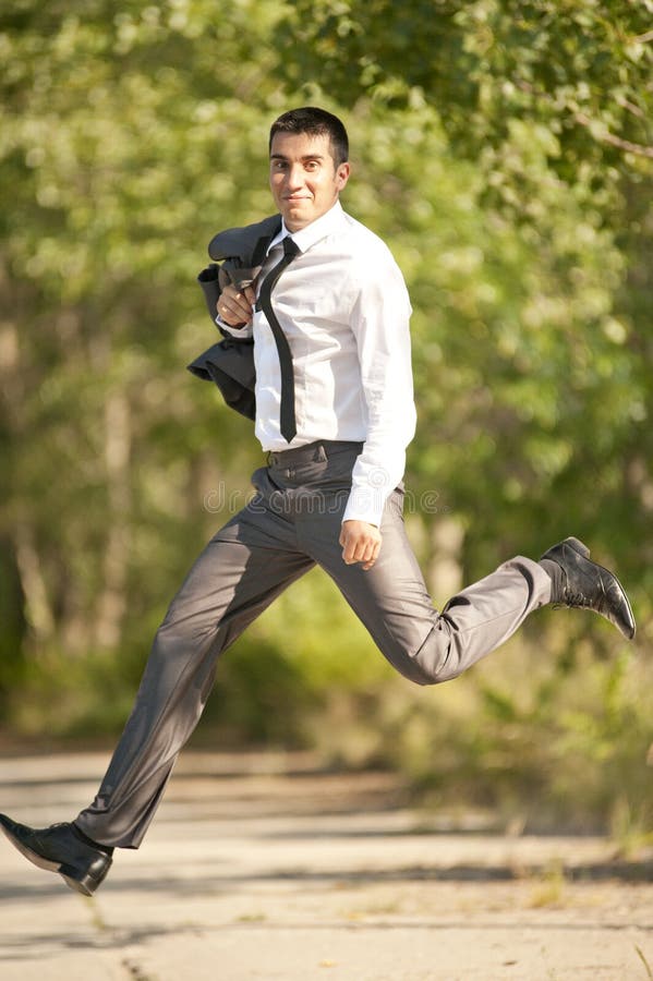 Young man jumping stock image. Image of looking, laptop - 25798215