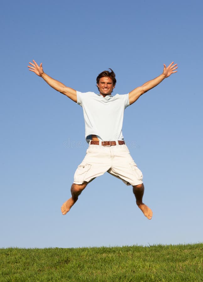 Young man jumping in air stock photo. Image of space - 17060364