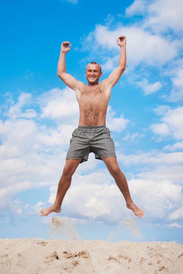 Young Man Jumping in the Air Against a Blue Sky Stock Photo - Image of ...