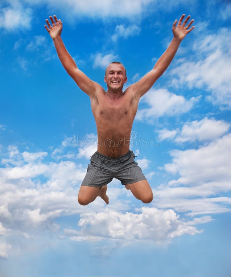 Young Man Jumping in the Air Against a Blue Sky Stock Photo - Image of ...