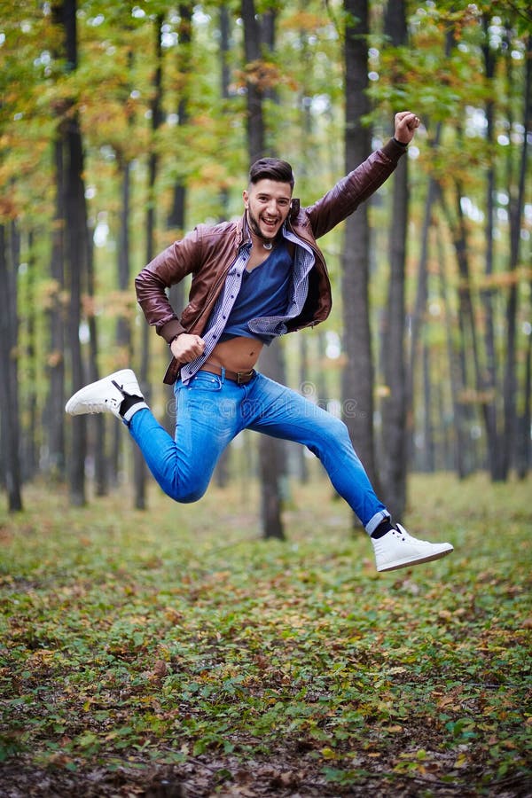 Young man jumping for joy stock photo. Image of success - 46354700