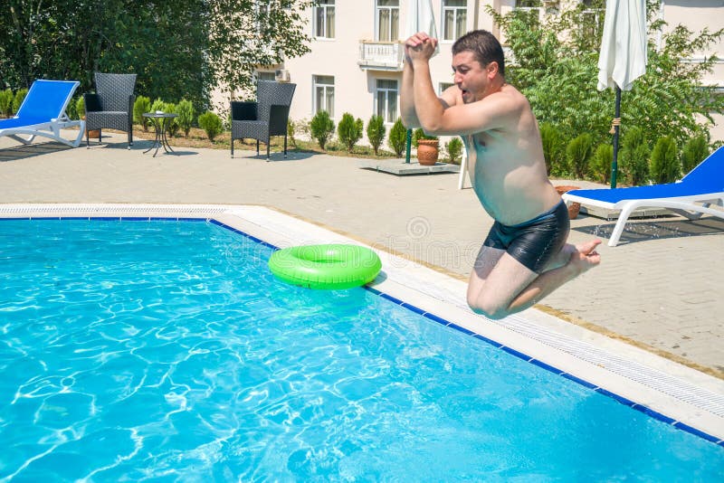 Young Man Jumping in Swimming Pool at Resort Stock Image - Image of ...