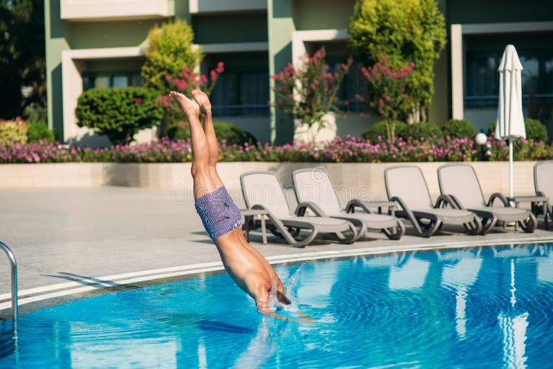 Young Man Jumping in Swimming Pool at Resort Stock Image - Image of ...