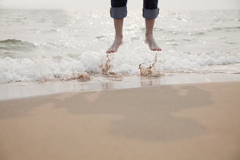 Young Man Jumping in the Waves Stock Image - Image of focus, splashing ...