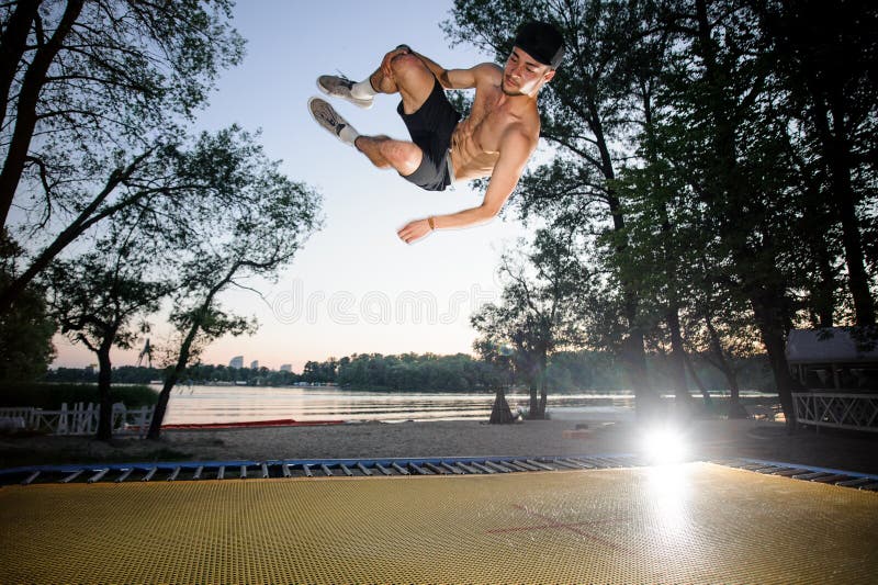 Young Man Jumping on the Yellow Trampoline Stock Image - Image of ...