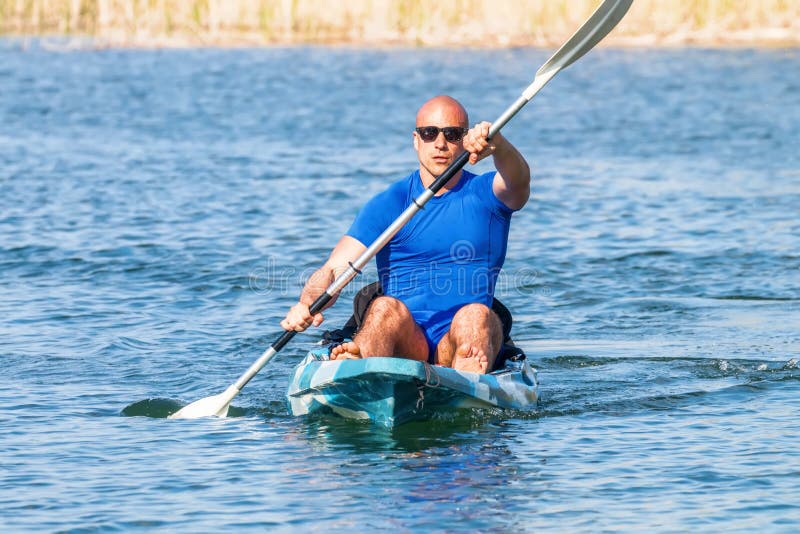 Young Man Kayaking on Lake. Lake Kayaking Stock Photo - Image of kayak ...