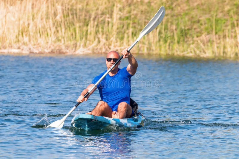Young Man Kayaking on Lake. Lake Kayaking Stock Image - Image of ...