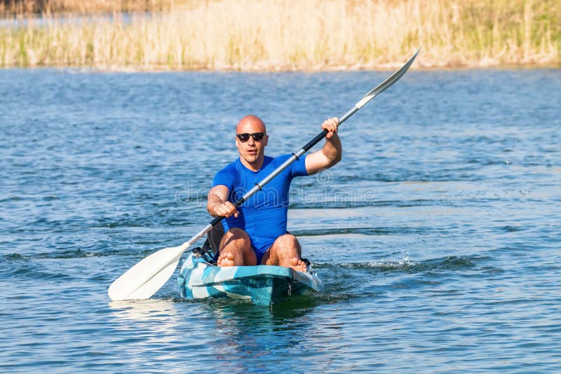 Young Man Kayaking on Lake. Lake Kayaking Stock Photo - Image of sport ...