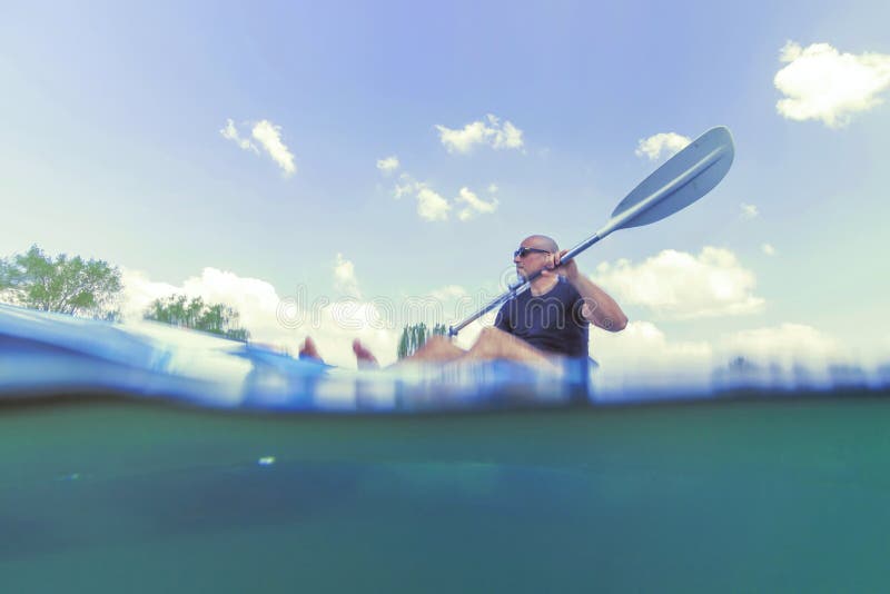 Young Man Kayaking on Lake, Kayaking Underwater View, Split Shot Stock ...