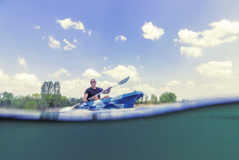 Young Man Kayaking on Lake, Kayaking Underwater View, Split Shot Stock ...