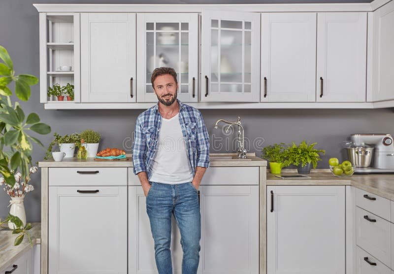 Young man in the kitchen stock image. Image of person - 136516933