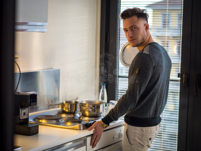 Young Man in Kitchen at Home, Cooking at the Stove Stock Image - Image ...
