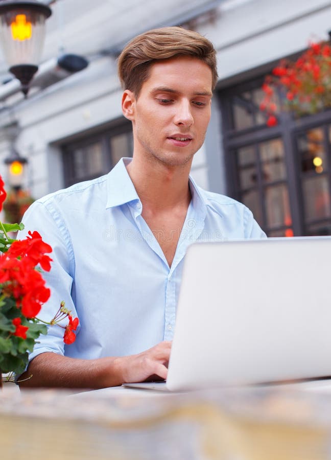 Young Man with Laptop Outdoors Stock Photo - Image of cafe, male: 36579992