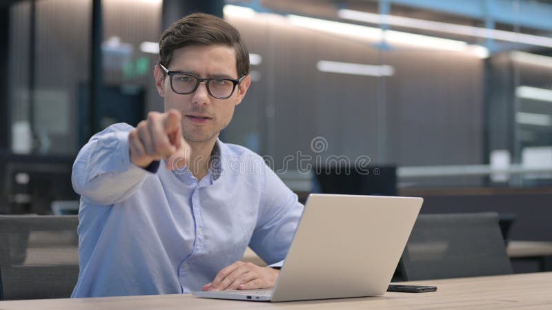 Young Man with Laptop Pointing at the Camera Stock Photo - Image of ...