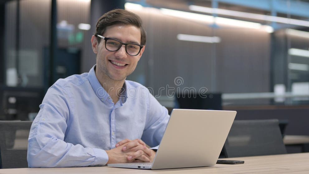 Young Man with Laptop Smiling at Camera Stock Image - Image of ...