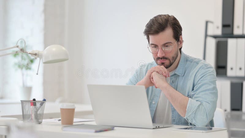 Young Man with Laptop Thinking at Work Stock Image - Image of ...