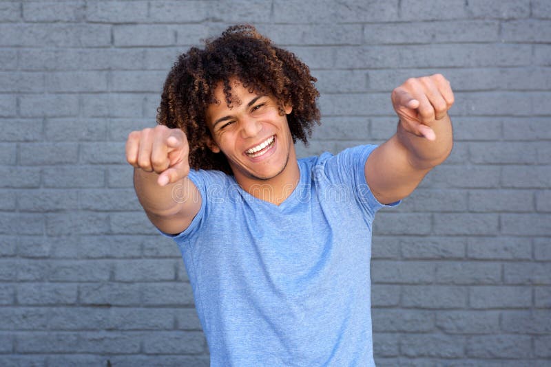 Young Man Laughing and Pointing Fingers Stock Photo - Image of cheerful ...