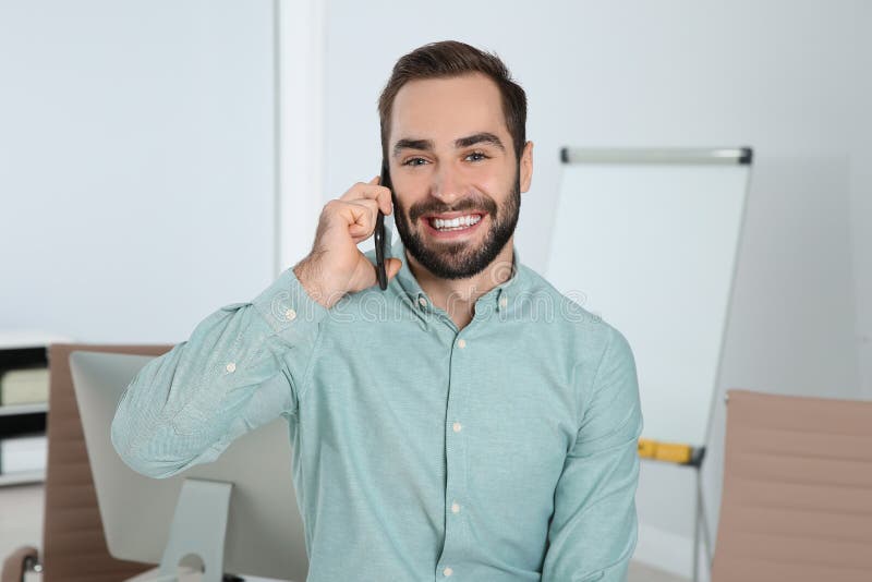 Young Man Laughing while Talking on Phone Stock Photo - Image of ...