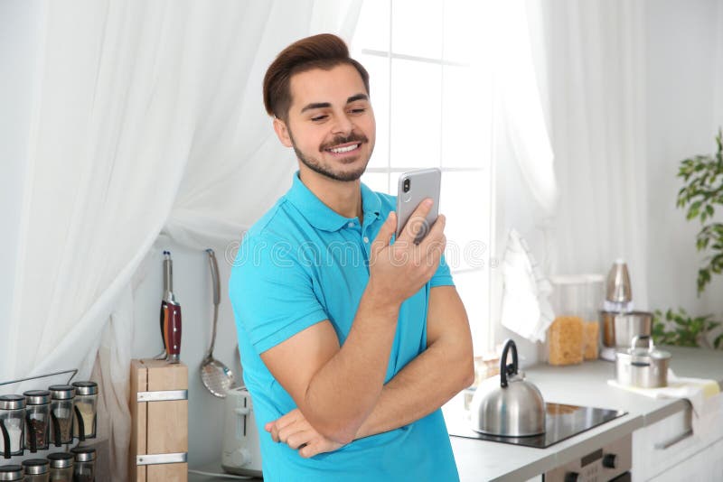 Young Man Laughing while Using Smartphone Stock Image - Image of humor ...
