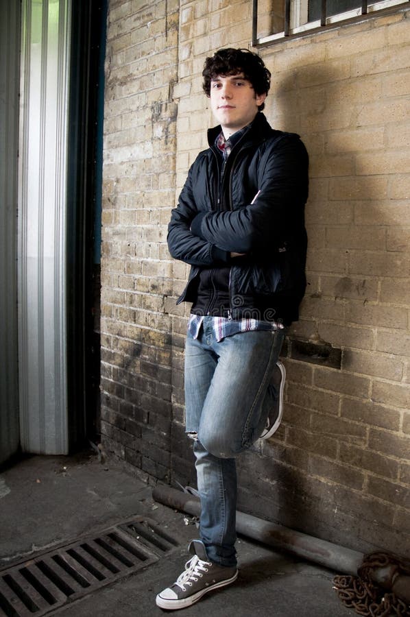 Young Man Leaning Against Brick Wall Stock Photo - Image of young, body ...