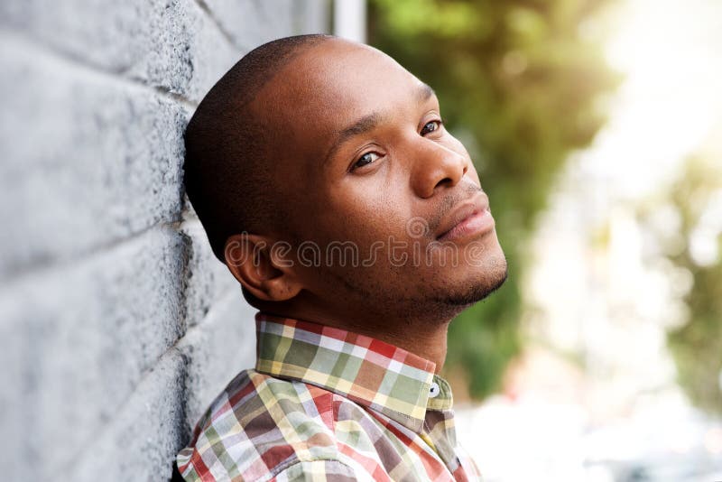 Young Man Leaning Against Wall and Thinking Stock Photo - Image of ...