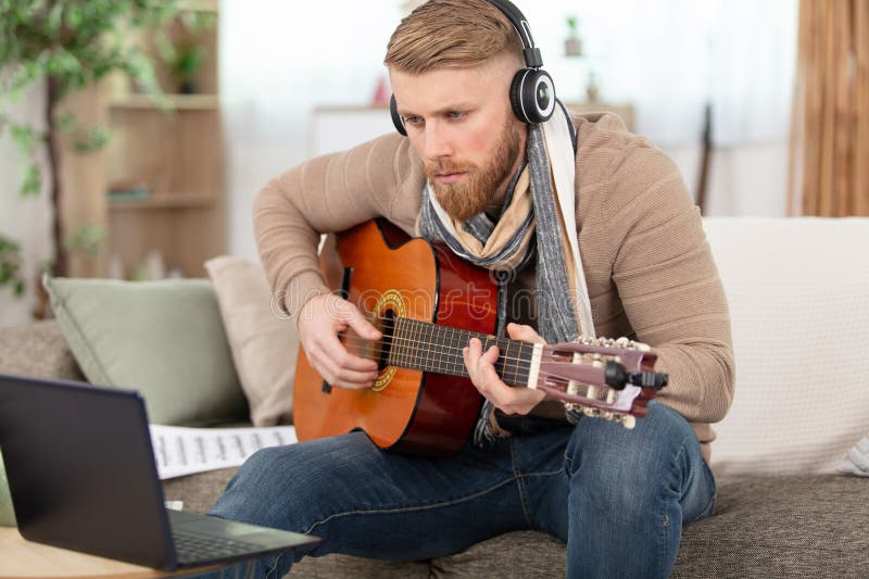 Young Man Learning How To Play Guitar on Computer Stock Image - Image ...