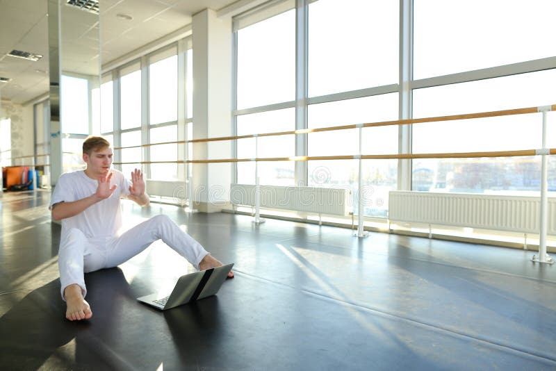 Young Man Learning New Dancing Technique with Laptop Tutorial. Stock ...