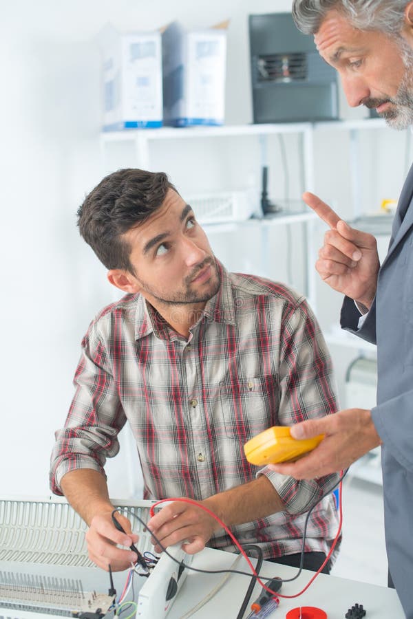 Young Man Learning To Calibrate with Multimeter Stock Photo - Image of ...