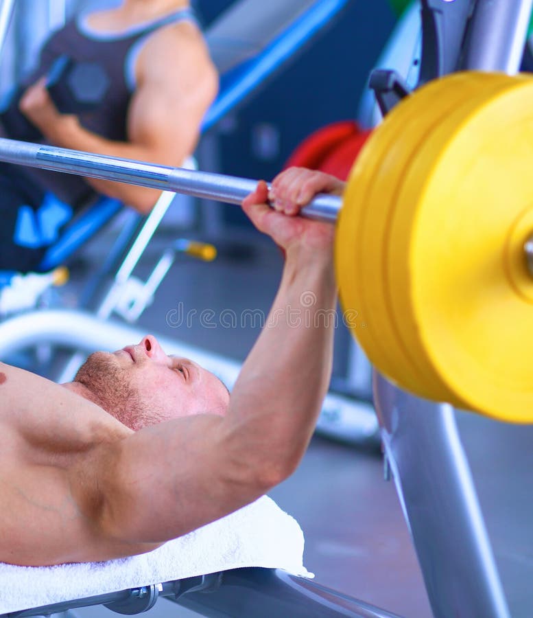 Young Man Lifting the Barbell in Gym with Instructor Stock Photo ...