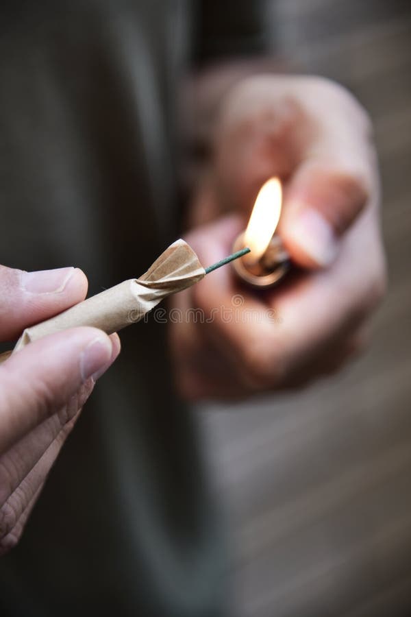 Young Man Lighting a Firecracker Stock Photo - Image of holiday ...