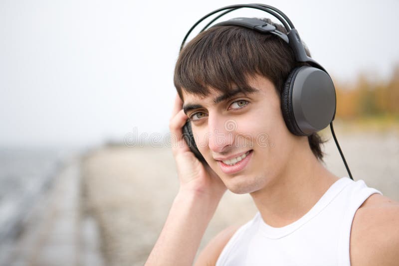 Young man listen to music stock image. Image of headphones - 13837583