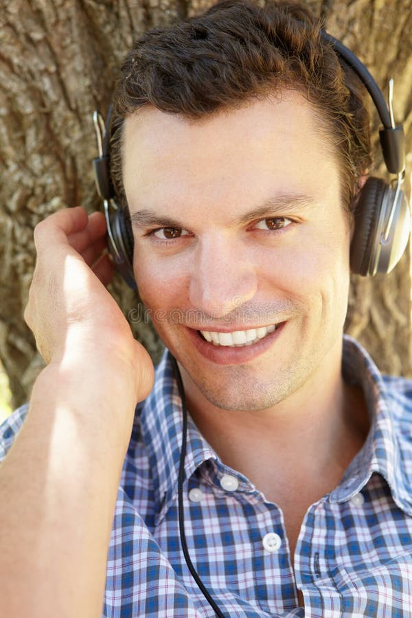 Young man listening music stock photo. Image of brown - 19857724