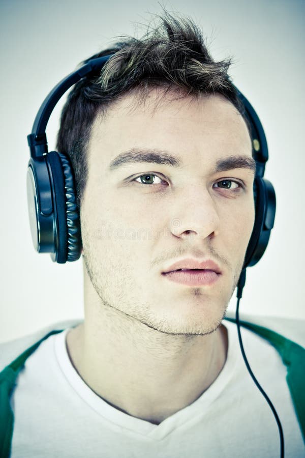 Young man listening music stock image. Image of attractive - 21620577