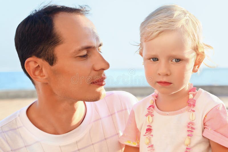 Young Man with Little Girl on Stony Beach Stock Photo - Image of family ...